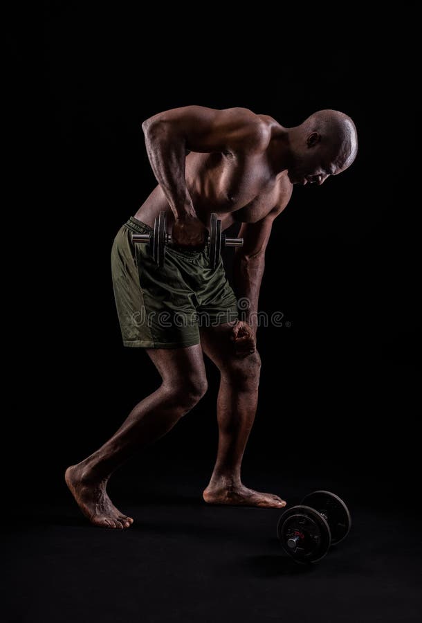 Side View of a Muscular Man Standing Leaning Forward Doing Triceps ...