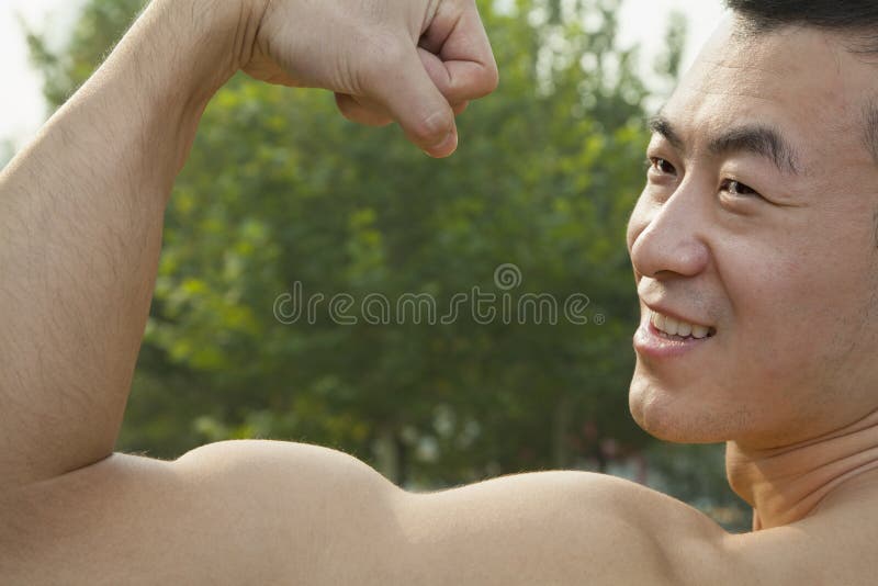 Side View of Muscular Smiling Man Showing Off and Flexing His Bicep ...