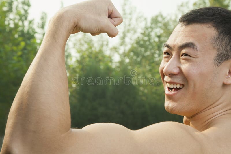 Side View of Muscular Smiling Man Showing Off and Flexing His Bicep ...