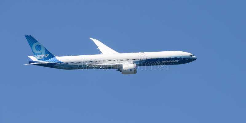 Side View of a New 777X in Flight Turning Against a Blue Sky Editorial ...