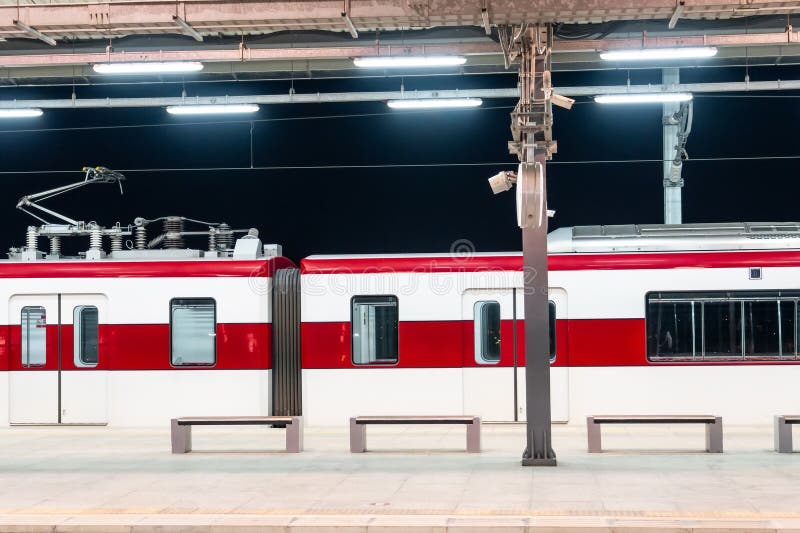 Side View of the Night Time Station Platform and Commuter Train in the ...