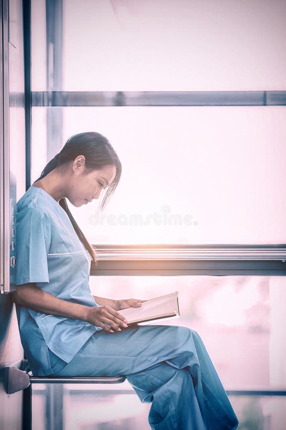 Side View of Nurse Looking at Diary Stock Photo - Image of data ...