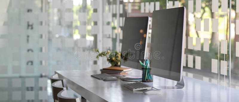 Side View of Office Desk with Two Computer and Office Supplies in ...
