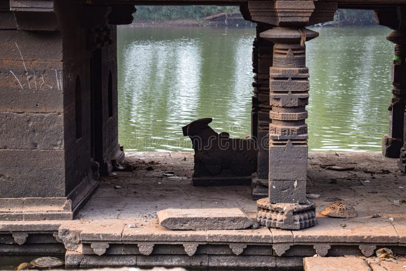 .Side View of an Old Hindu Temple,there is a Ancient Bull Statue in ...