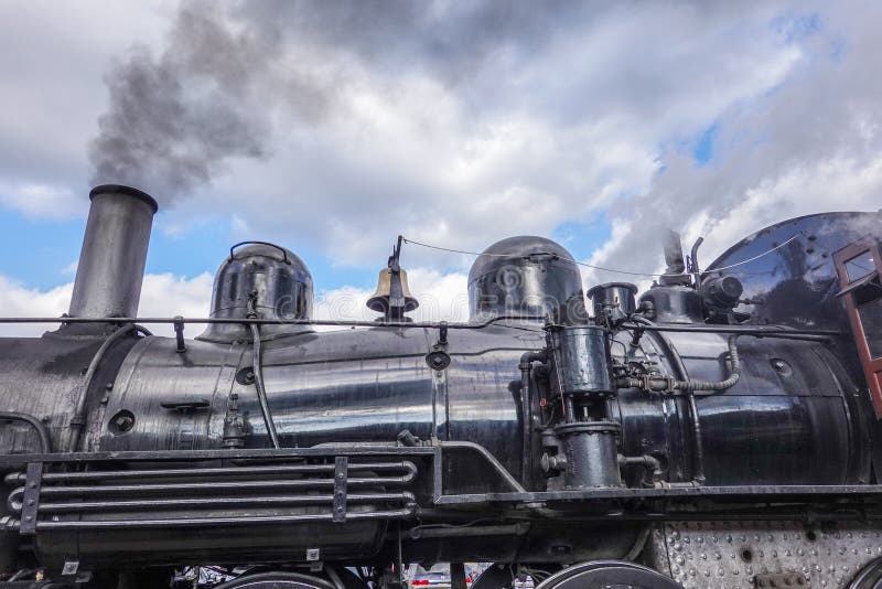 Side View of an Old Steam Locomotive Engine with Smoke Coming from the ...