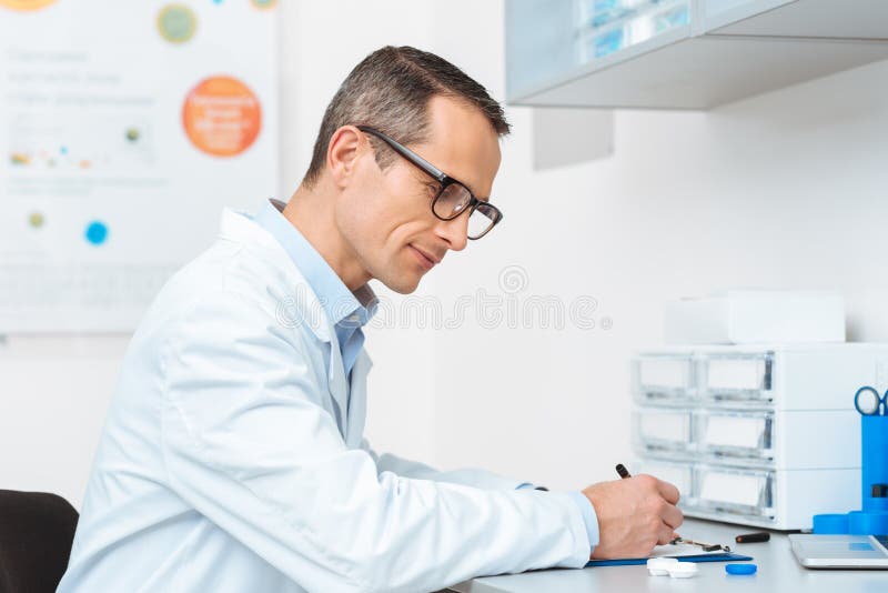 Side View of Ophthalmologist Working at Table Stock Image - Image of ...