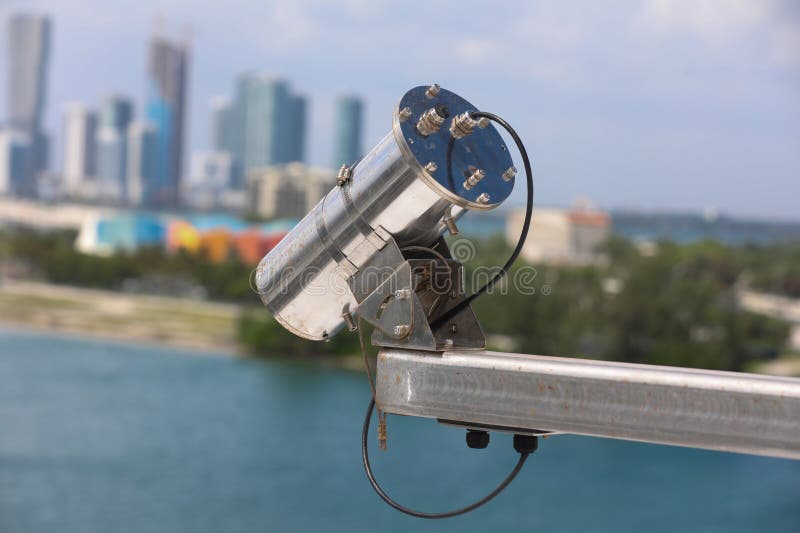 Side View of an Outdoor Mounted Security Camera with Sky, Clouds and ...