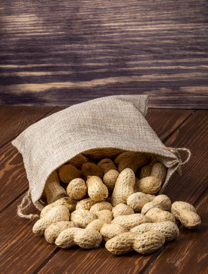 Side View Peanuts in Shell from a Bag on a Wooden Table Stock Image ...