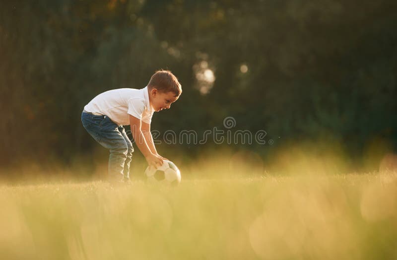 Side View, Playing Soccer. Little Boy is Playing Outdoors at Daytime ...