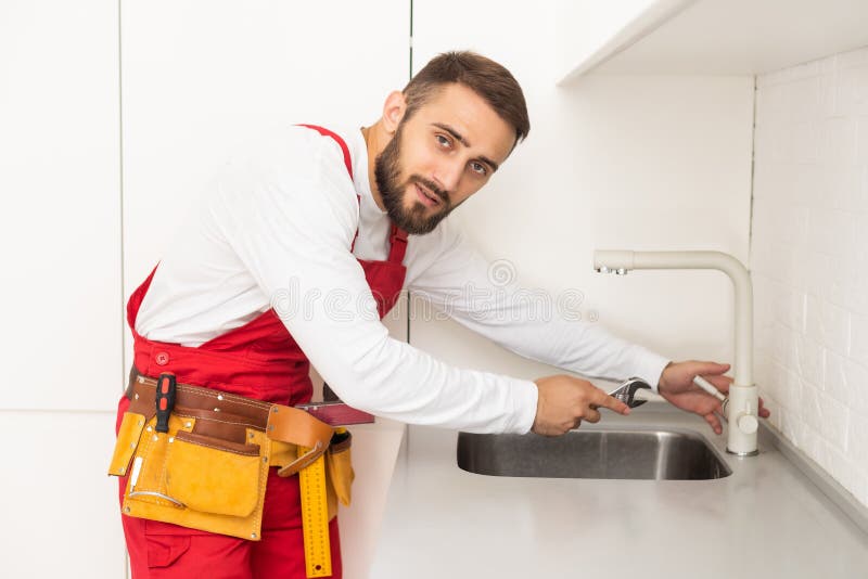 Side View of a Plumber Fixing Water Tap in Kitchen Stock Photo - Image ...