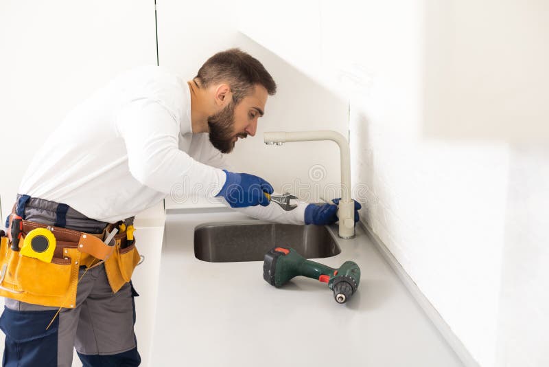 Side View of a Plumber Fixing Water Tap in Kitchen Stock Image - Image ...
