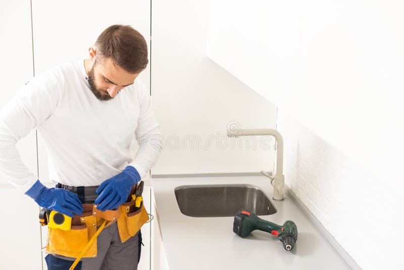Side View of a Plumber Fixing Water Tap in Kitchen Stock Photo - Image ...