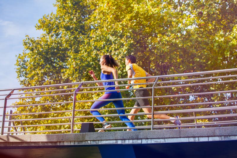 Portrait of Active People Running Across a Bridge Stock Image - Image ...
