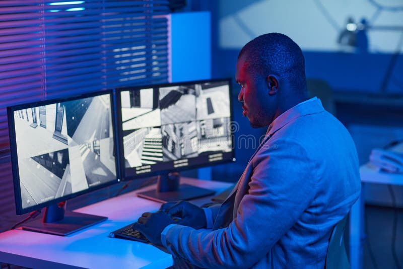 Black Man Looking at Surveillance Camera Footage in Security Center ... Black Man Looking at Surveillance Camera Footage in Security Center ...