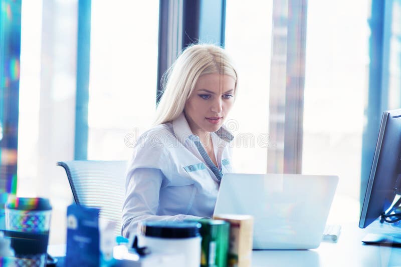 Side View Portrait of Businesswoman Using Computer at Office Desk Stock ...