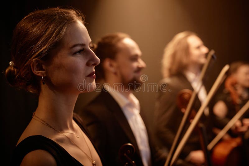 Young Woman on Stage with Orchestra Stock Image - Image of spotlight ...