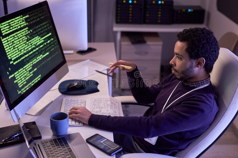 Male It Programmer Writing Code And Using Computer At Office Workplace