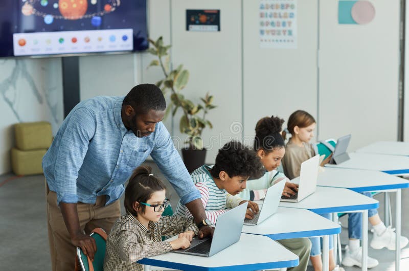 Teacher Helping Students in it Class Stock Image - Image of boys ...
