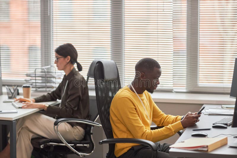 Two Office Workers at Desks Back To Back Working in Office Stock Photo ...