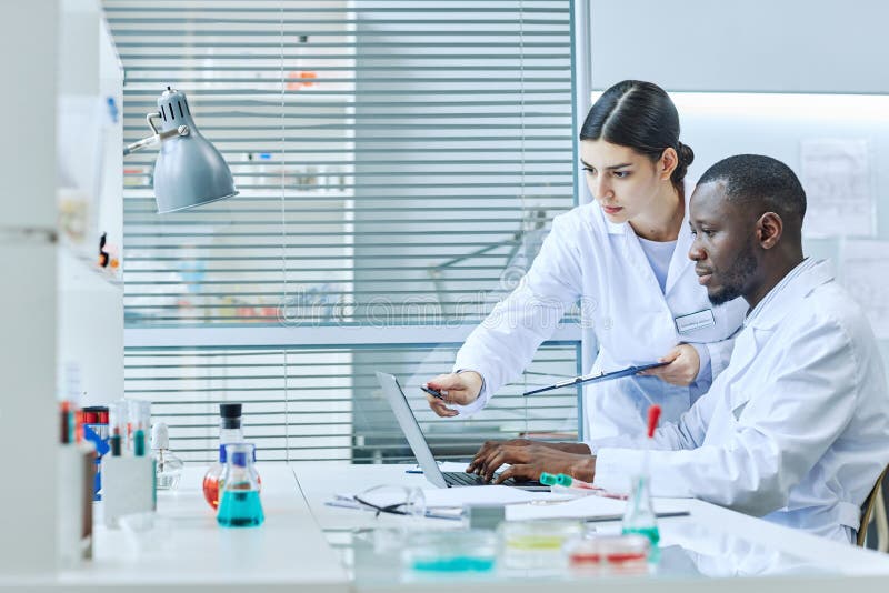 Two Scientists Using Laptop in Laboratory Doing Research Stock Photo ...