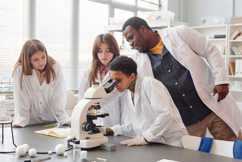 Kids Using Microscope in Science Lab Stock Image - Image of discussion ...
