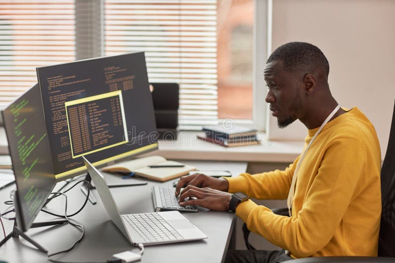 Young Black Man Typing at Keyboard and Writing Code in it Development ...