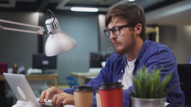 Side View of Programmer Working on Computer in Office Stock Footage ...
