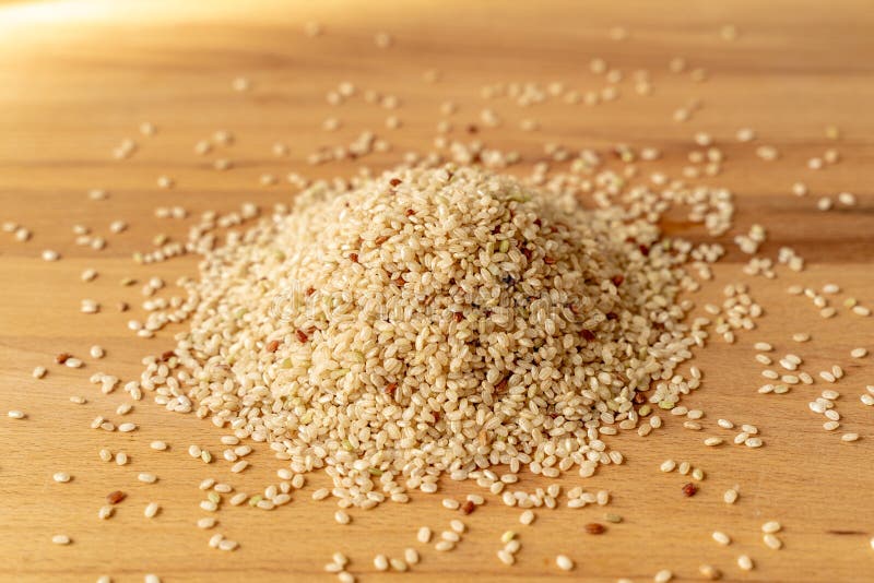Raw Brown Rice on a Wooden Table. Organic Brown Rice on a Table Stock ...