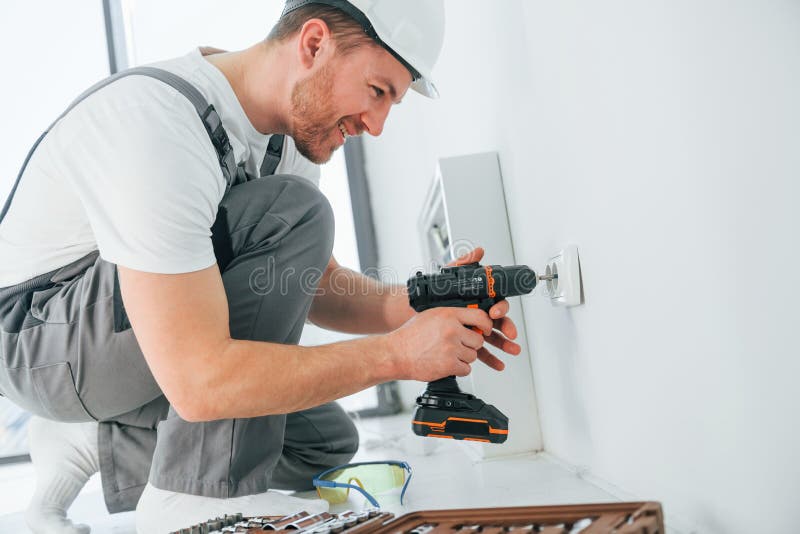 Side View. Repairman is Working Indoors in the Modern Room Stock Photo ...