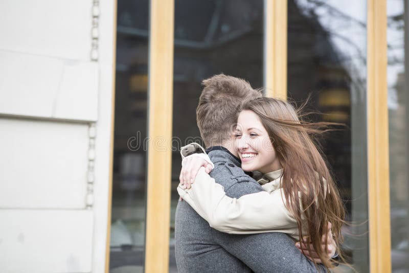 Side View of Romantic Couple Hugging Outside Cafe Stock Image - Image ...