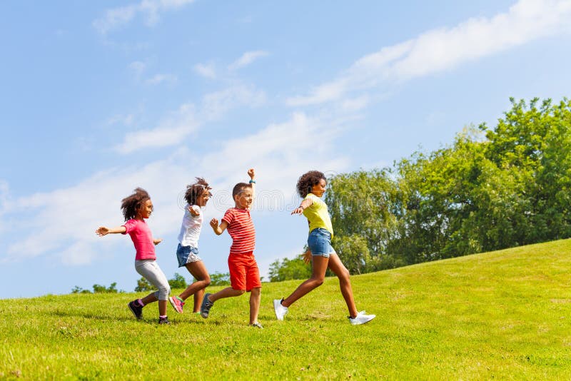 Side View of Running Kids Group in the Park Lawn Stock Photo - Image of ...
