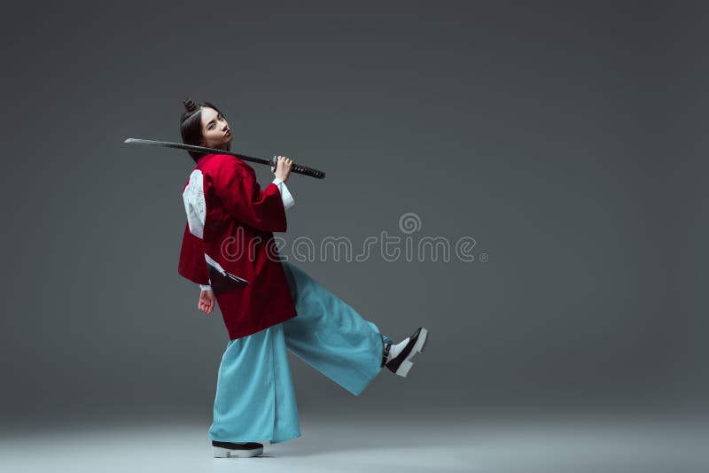 Side View of Samurai in Kimono Walking with Katana and Looking at ...