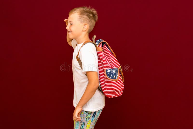 Side View of School Boy with Backpack, on Red Wall Stock Image - Image ...