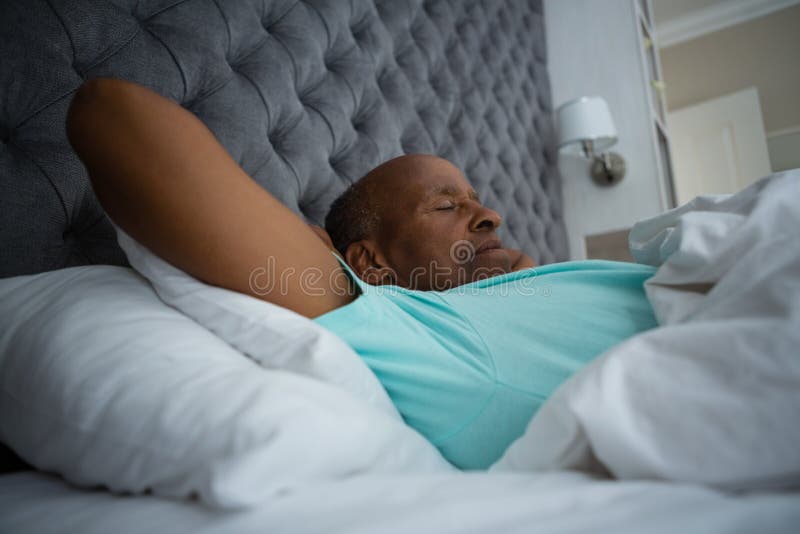 Side View of Senior Man Sleeping on Bed at Home Stock Photo - Image of ...