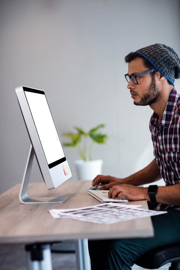 Side View of Serious Casual Man Working at Computer Desk Stock Photo ...