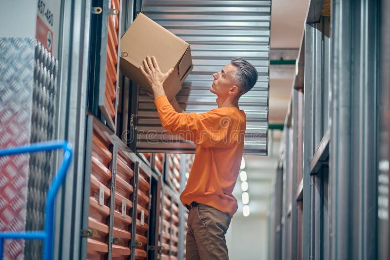 Concentrated Warehouse Worker Unloading Goods Indoors Stock Photo ...