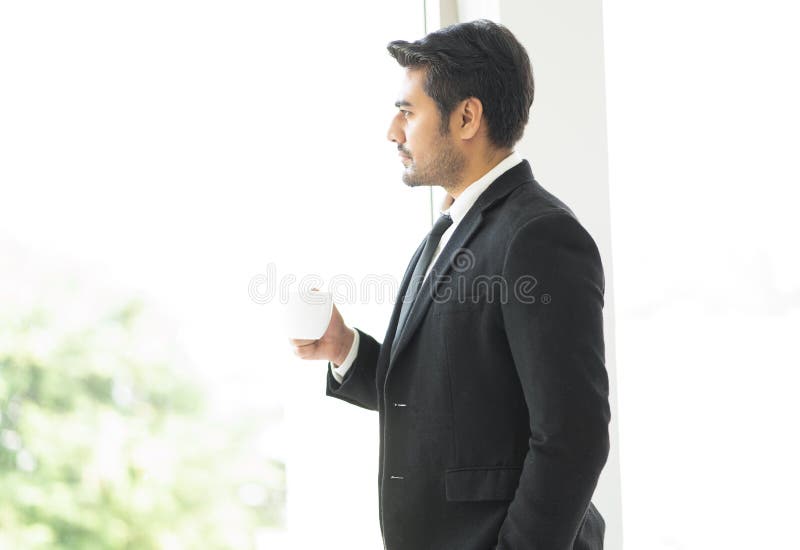 Side View of Serious Pensive Manager Having a Cup of Coffee while ...