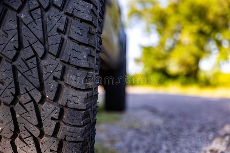 Side View of a Sleek Black Vehicle Tire on an Asphalt Road Stock Photo ...