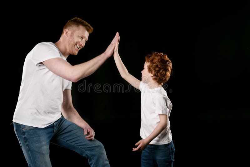 Side View of Smiling Father Giving High Five To Son Stock Image - Image ...