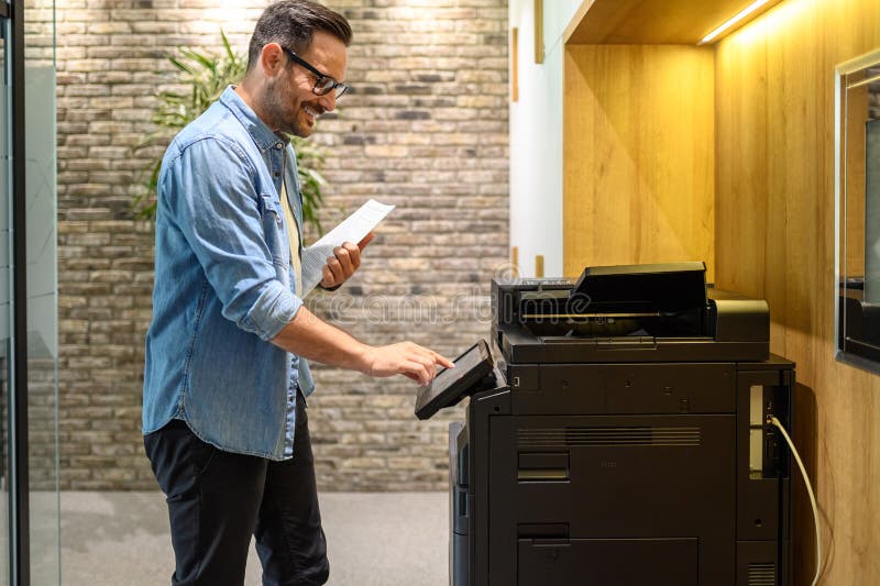 Side View of Smiling Male Professional Holding Documents and Using ...