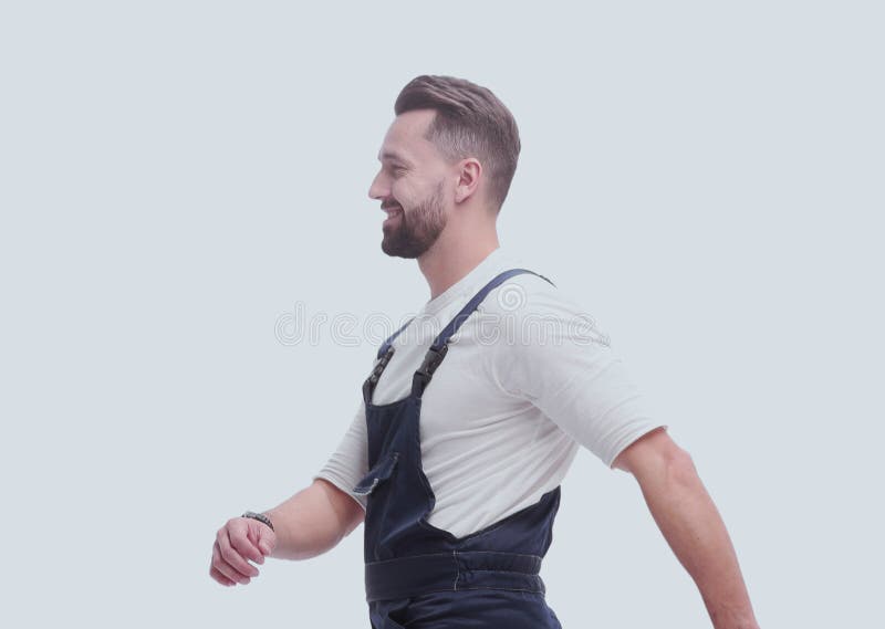 Side View. Smiling Man in Overalls Confidently Striding Forward Stock ...