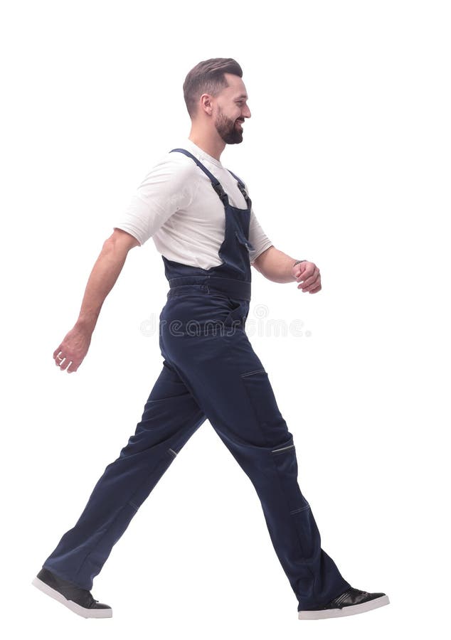 Side View. Smiling Man in Overalls Confidently Striding Forward Stock ...