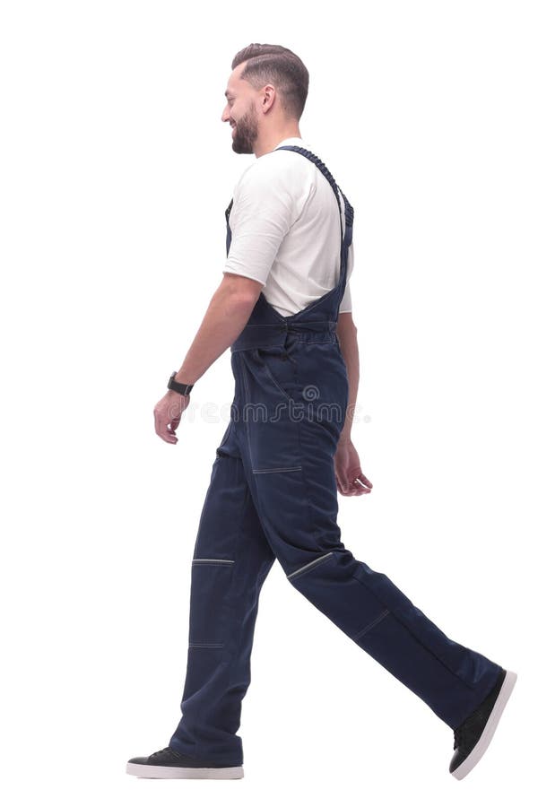 Side View. Smiling Man in Overalls Confidently Striding Forward Stock ...