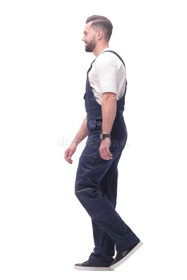 Side View. Smiling Man in Overalls Confidently Striding Forward Stock ...