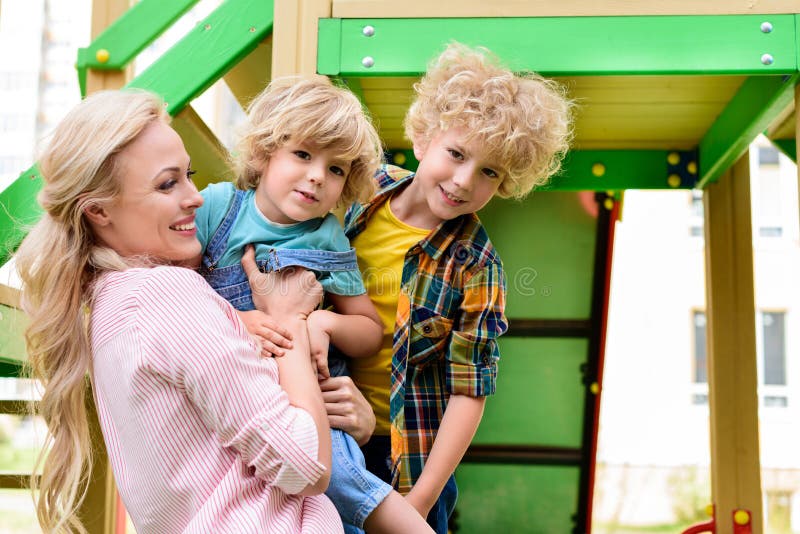 Side View of Smiling Mother with Two Adorable Little Sons Stock Photo ...