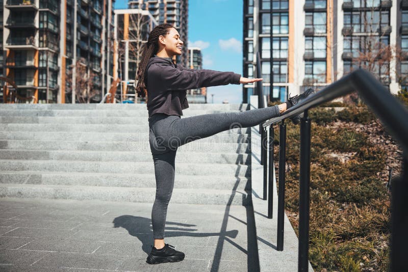 Pretty Lady Performing a Stretching Exercise Using the Handrail Stock ...