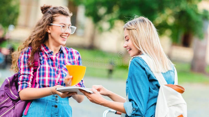 Side View of Smiling Students with Notebook Standing Stock Image ...