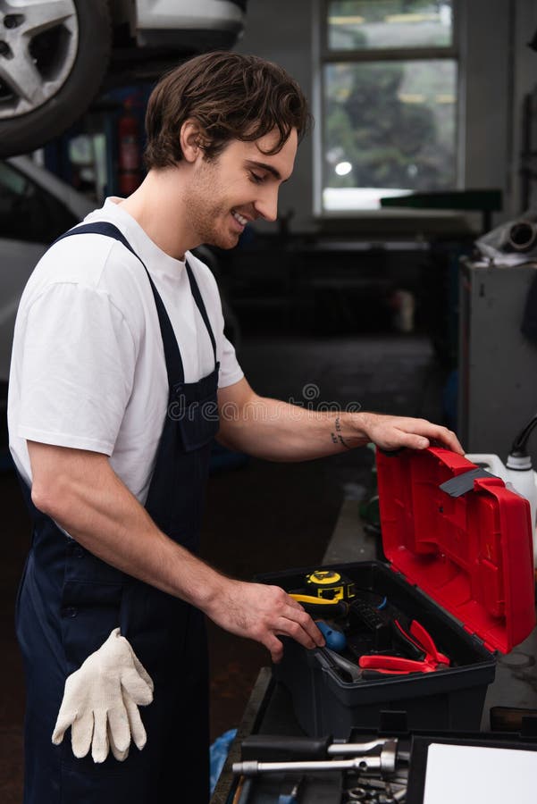 Side View of Smiling Workman Looking Stock Image - Image of blur ...