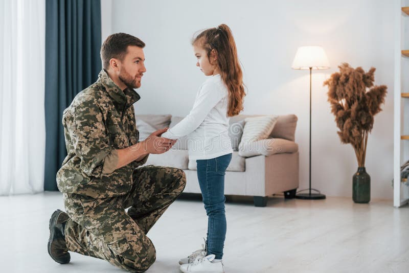 Side View. Soldier in Uniform is at Home with His Little Daughter Stock ...