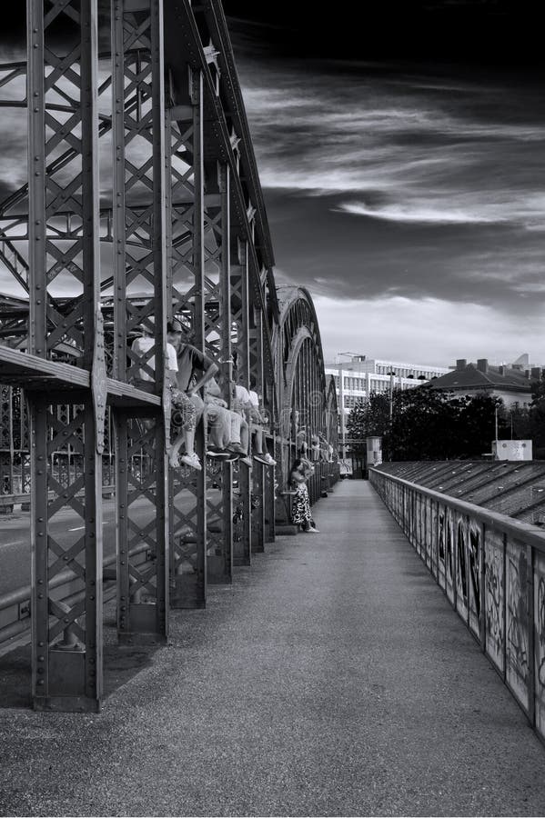 Side View of a Steel Structure Bridge and People Sitting Stock Photo ...